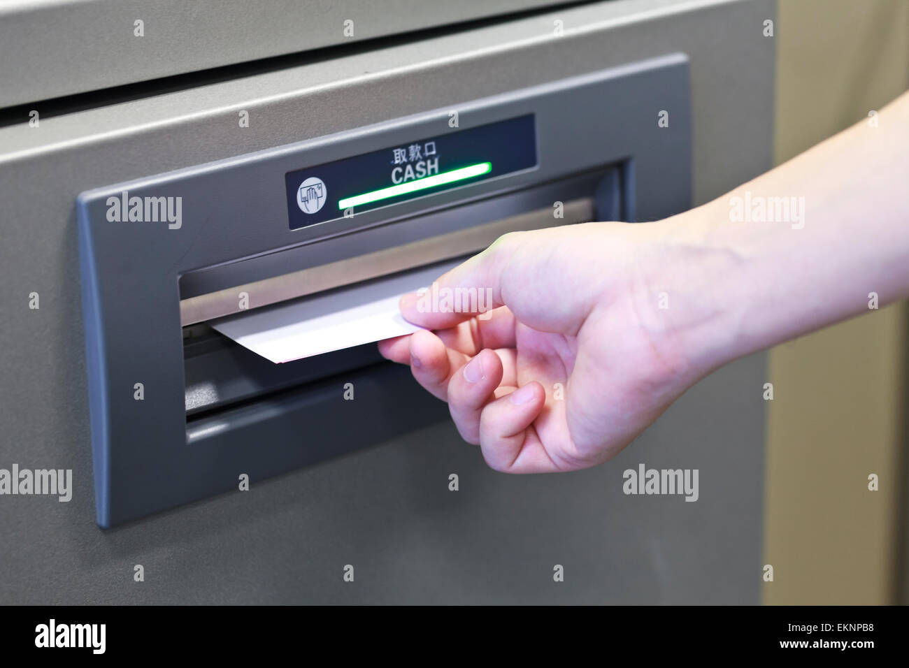 Taking money from ATM machine Stock Photo - Alamy