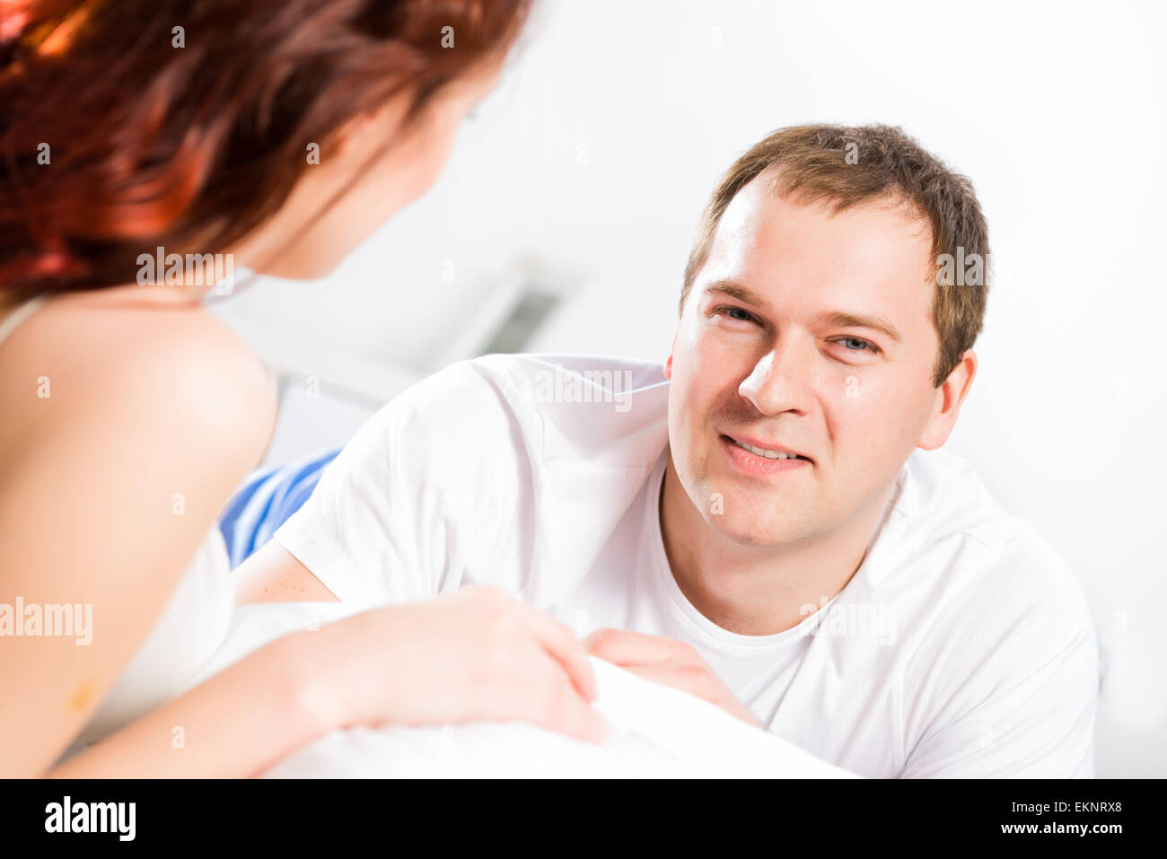 young man lying in bed with his girlfriend Stock Photo - Alamy