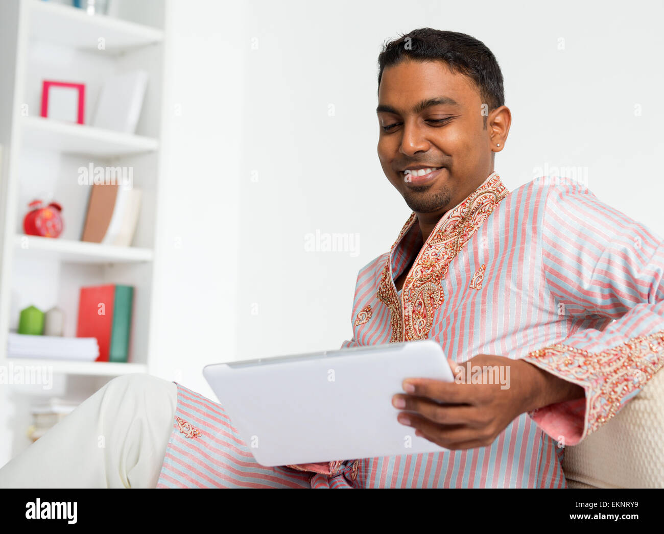 Indian man using digital tablet at home Stock Photo - Alamy