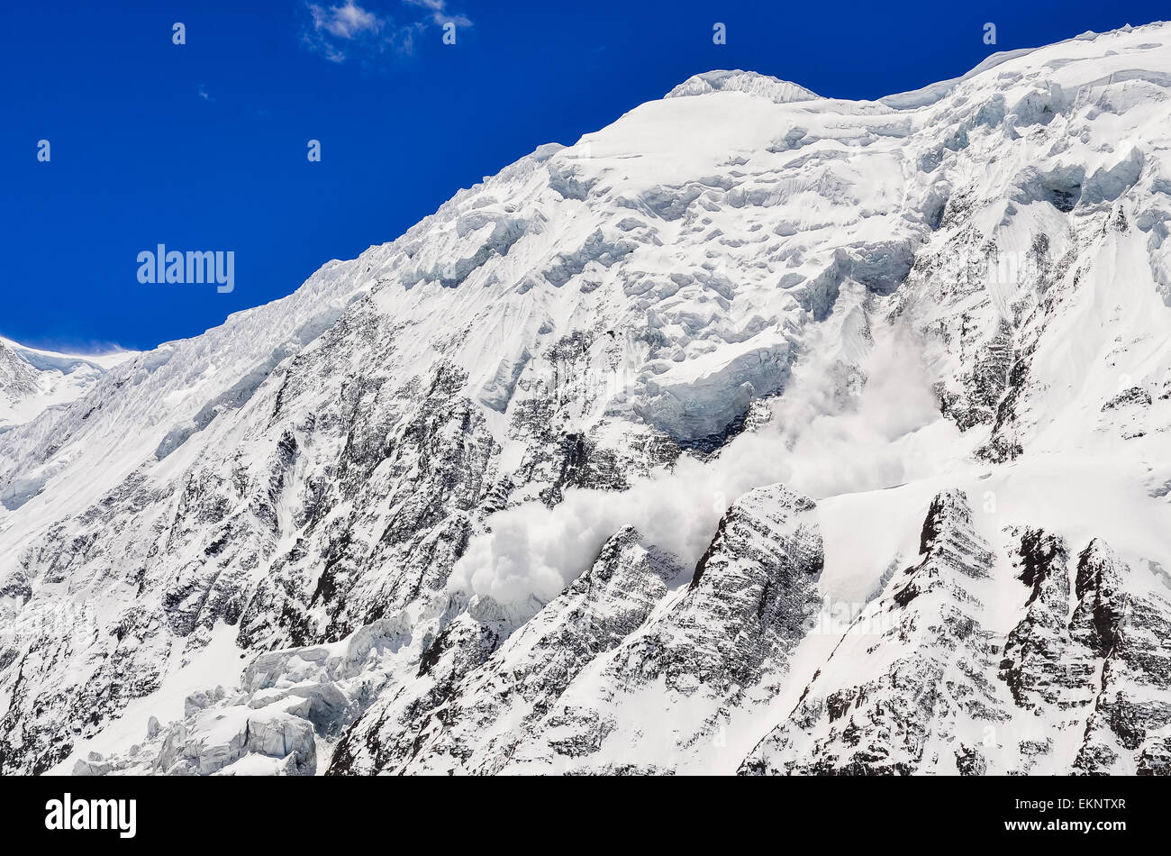 Avalanche falling from snowy frozen mountain peak Stock Photo - Alamy