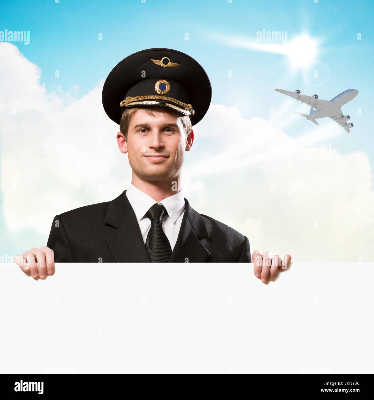 pilot in the form of holding an empty billboard Stock Photo - Alamy