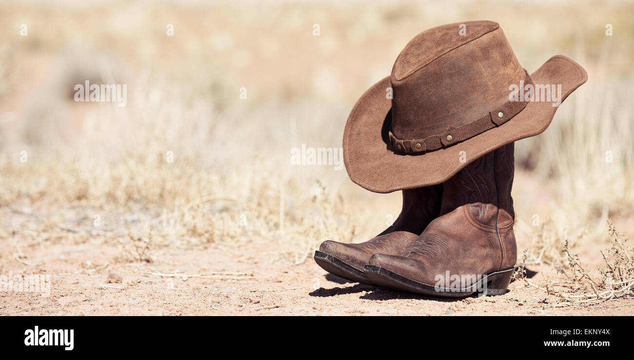 brown cowboy hat and boots outdoor Stock Photo - Alamy