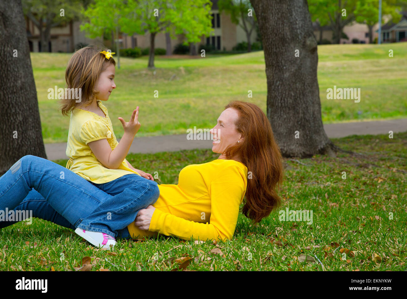 Daughter and mother playing counting lying on lawn Stock Photo - Alamy