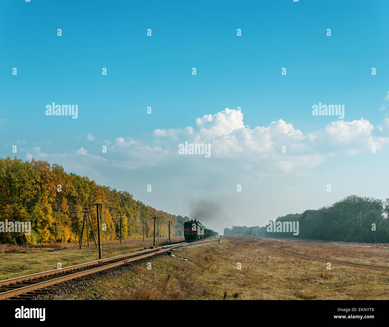 train with smoke over it under cloudy sky Stock Photo - Alamy