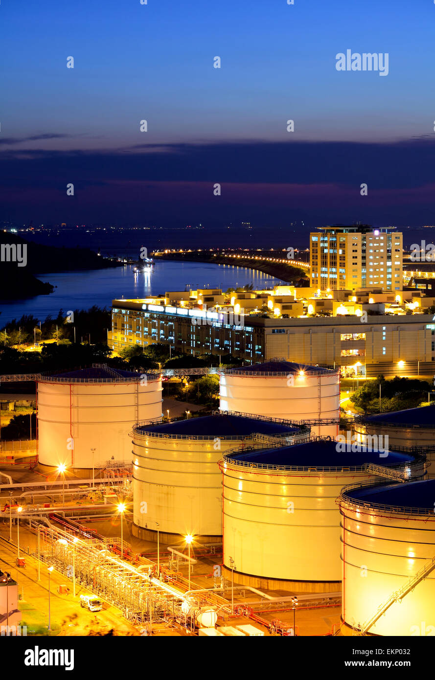 Oil tank in cargo terminal at night Stock Photo - Alamy