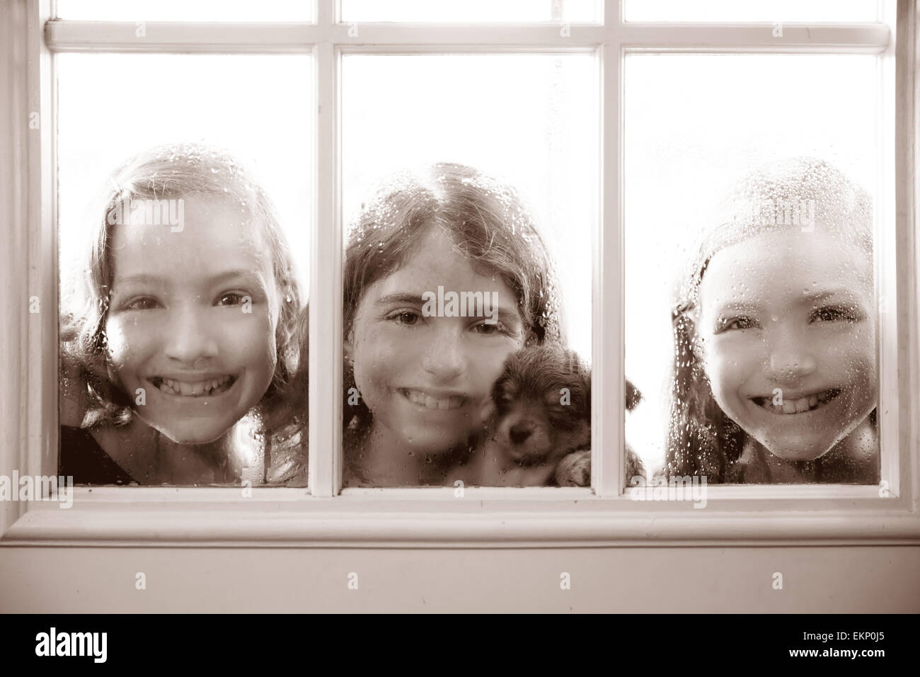 three sister friends looking through the rainy window Stock Photo - Alamy