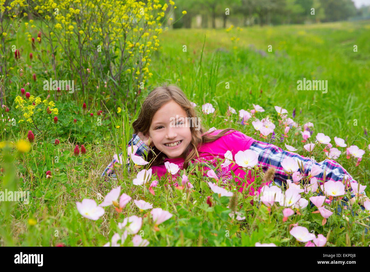 Happy relaxed kid girl on a spring flowers meadow Stock Photo - Alamy