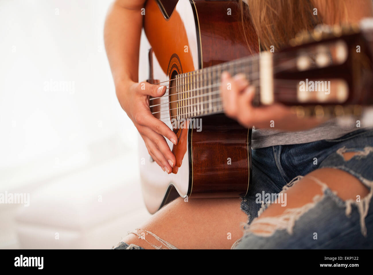 Closeup image of guitar in woman hands Stock Photo - Alamy