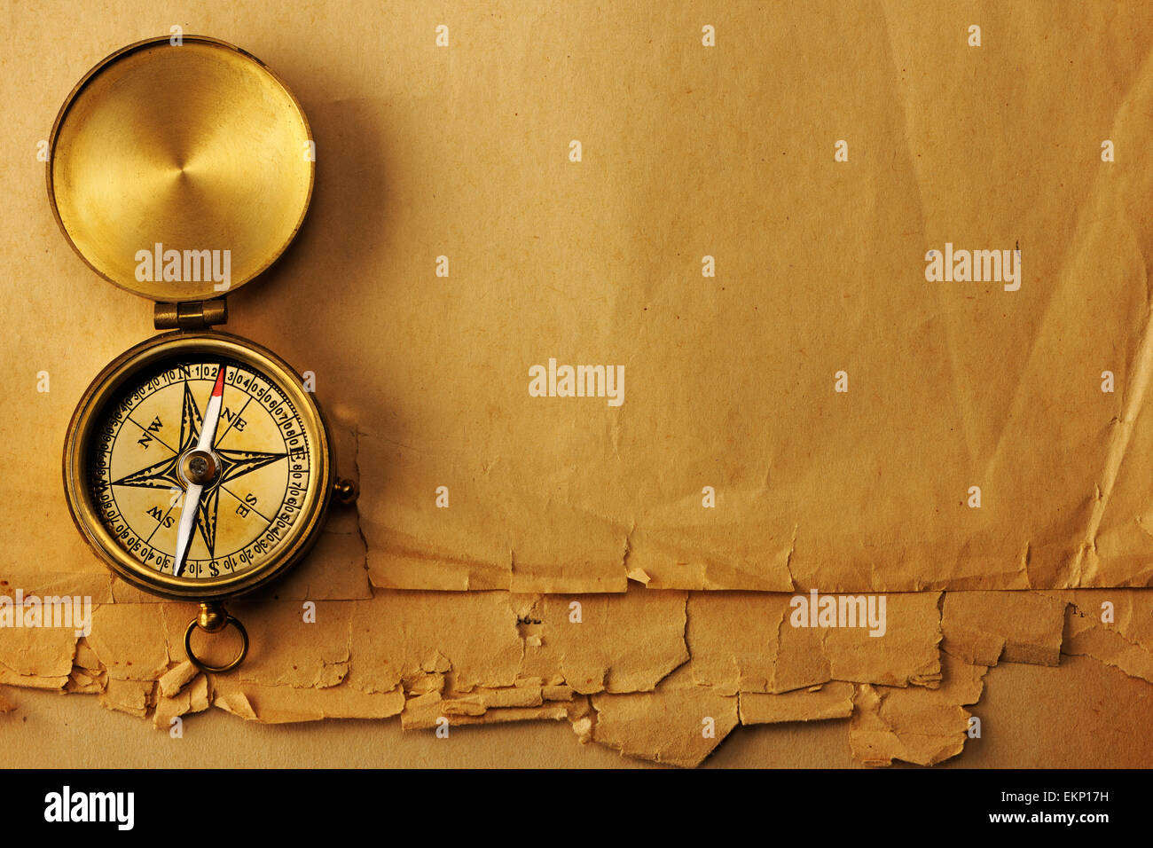 Antique brass compass over old background Stock Photo - Alamy