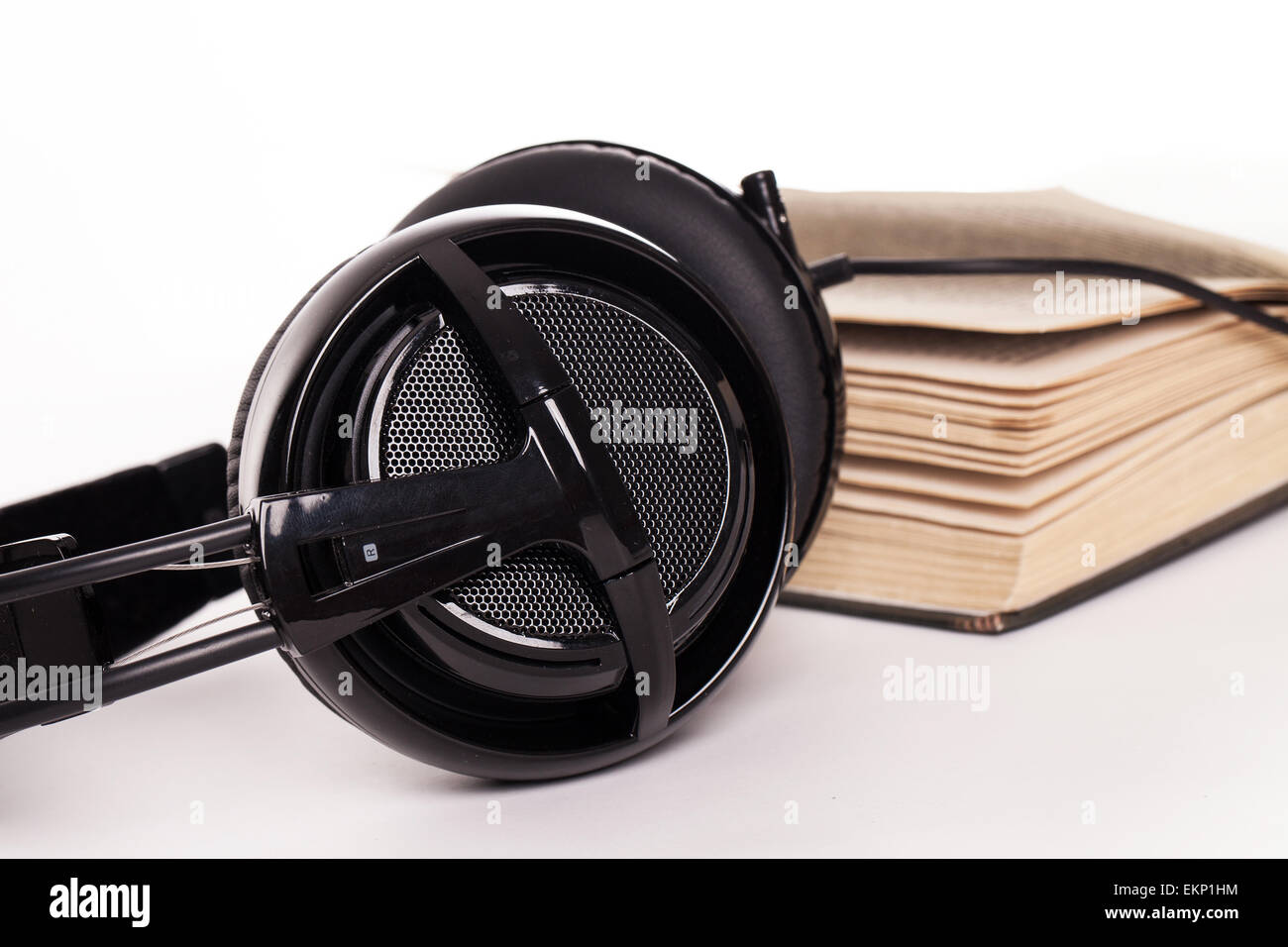 Headphones and book on a white background Stock Photo - Alamy