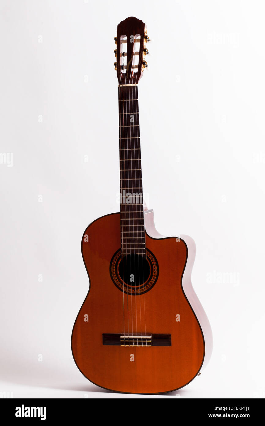 Old wooden guitar isolated over background Stock Photo - Alamy