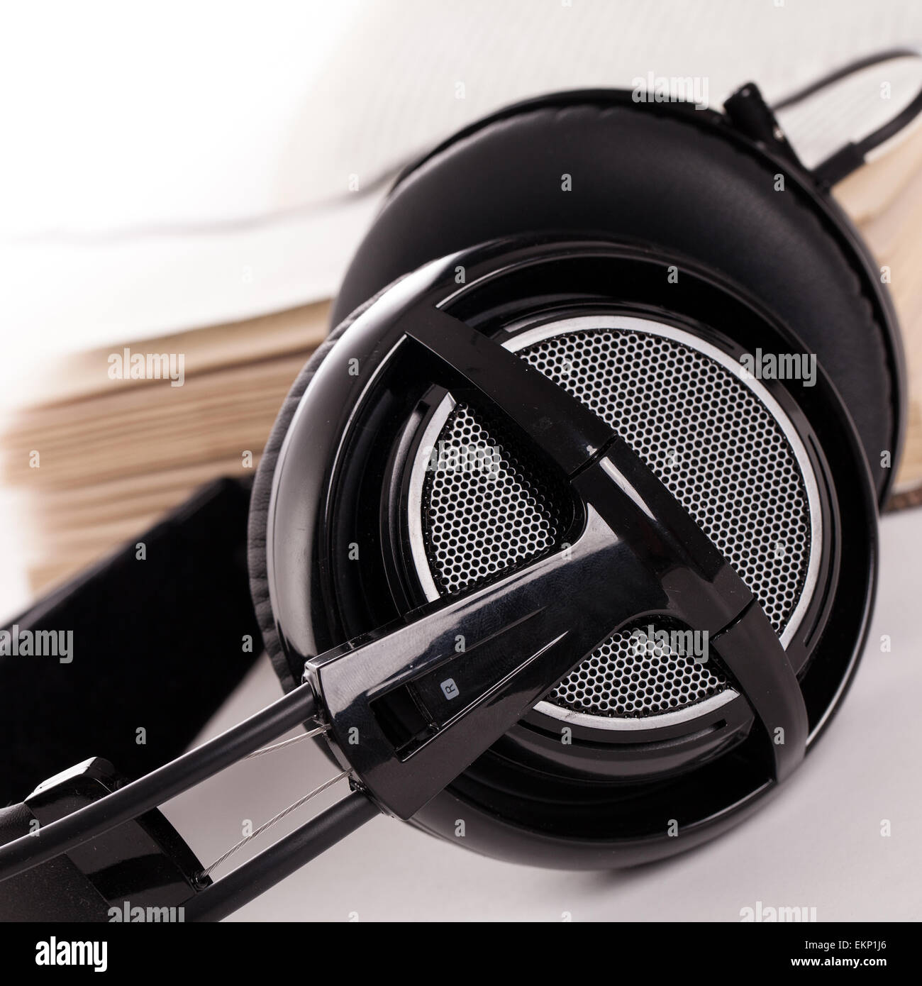 Headphones and book on a white background Stock Photo - Alamy