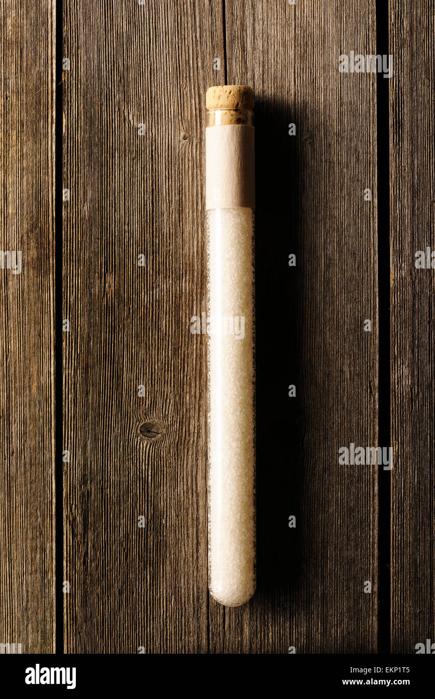 Sea salt in beaker on wooden table Stock Photo - Alamy