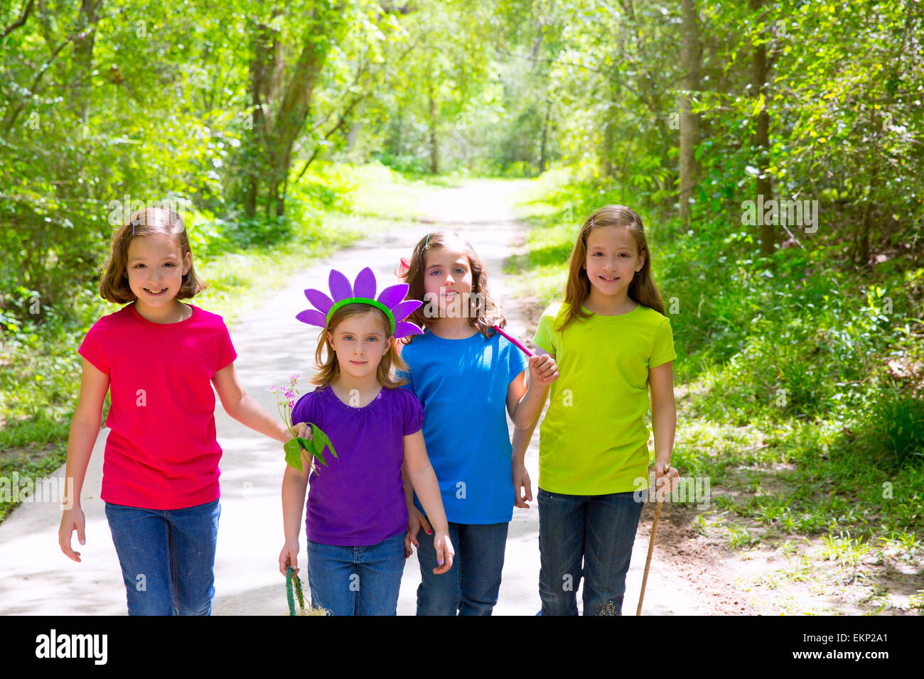 Friends and sister girls walking outdoor in forest track Stock Photo ...