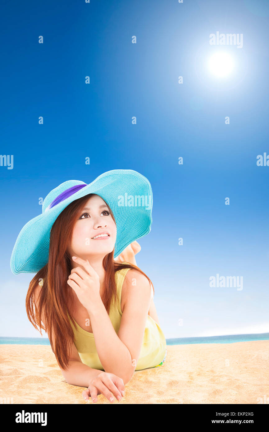 beautiful young woman lying on the beach Stock Photo - Alamy