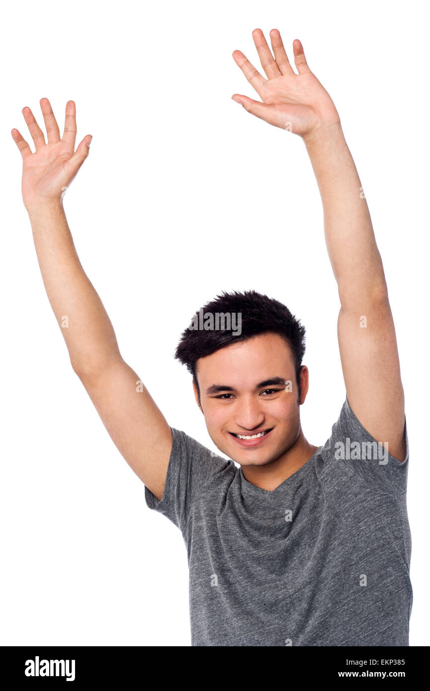 Cheerful young guy raising his arms Stock Photo - Alamy