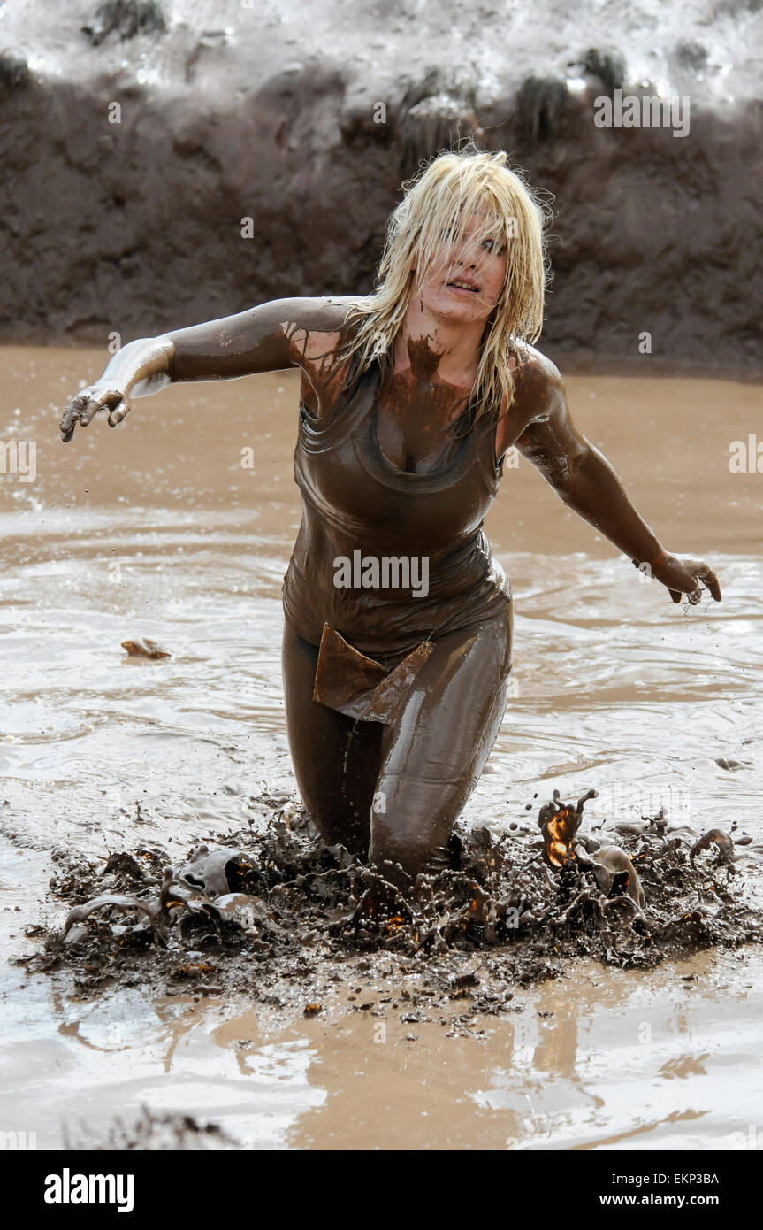 Mid 20s-30s blonde woman emerges from mud pool at finish line of an ...