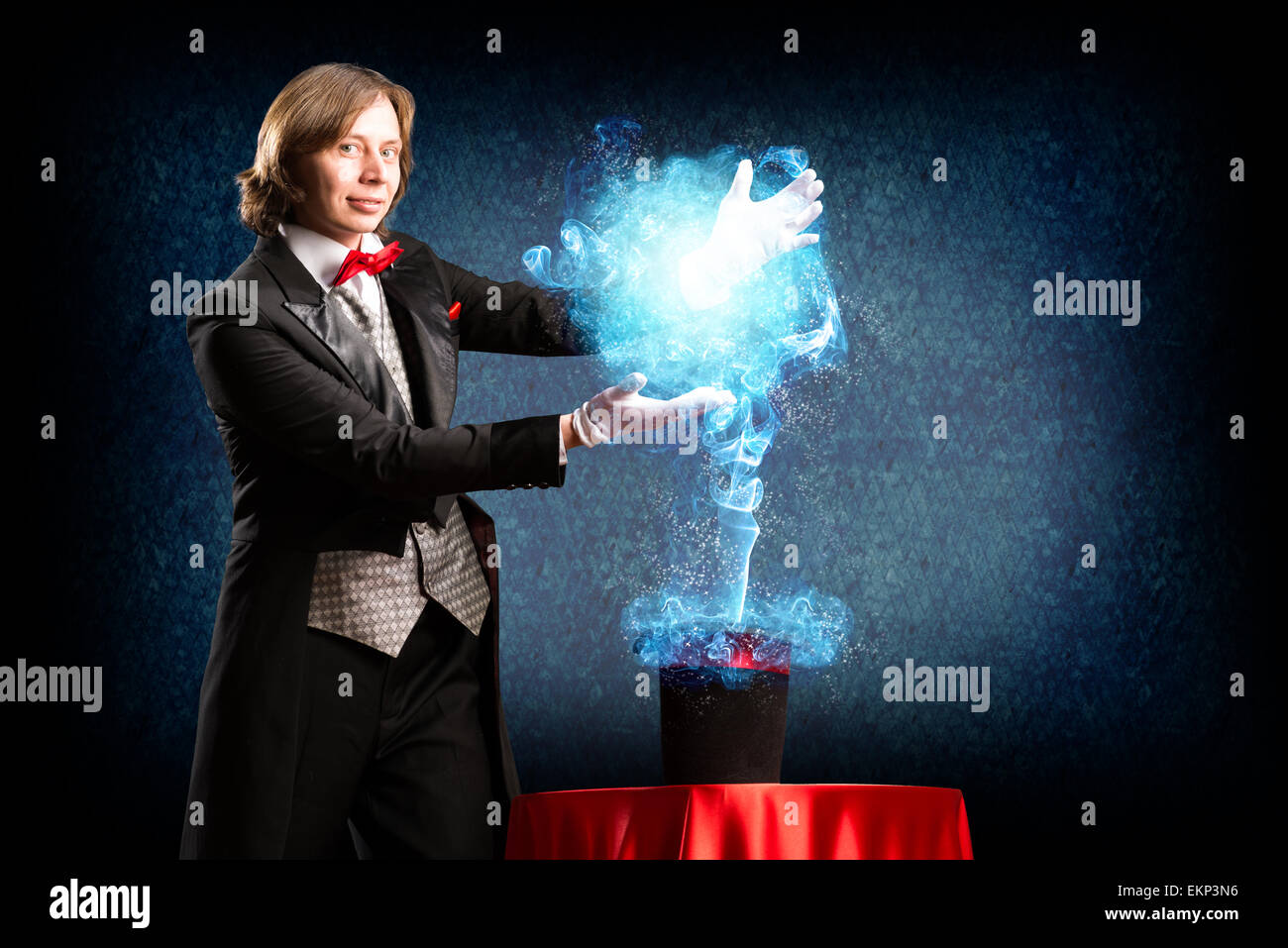 Magician performing trick, smoke coming out of hat Stock Photo - Alamy