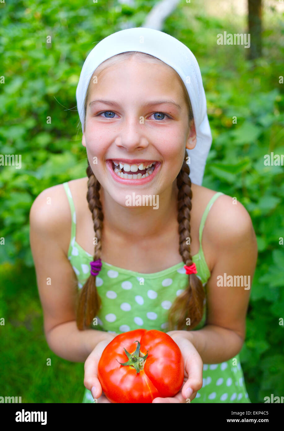 Girl holding a tomato Stock Photo - Alamy