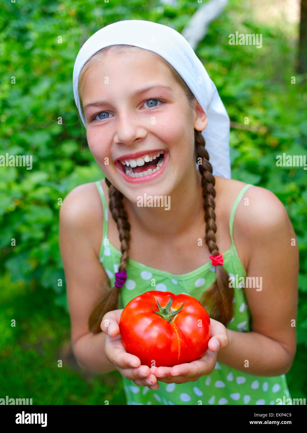 Girl holding a tomato Stock Photo - Alamy