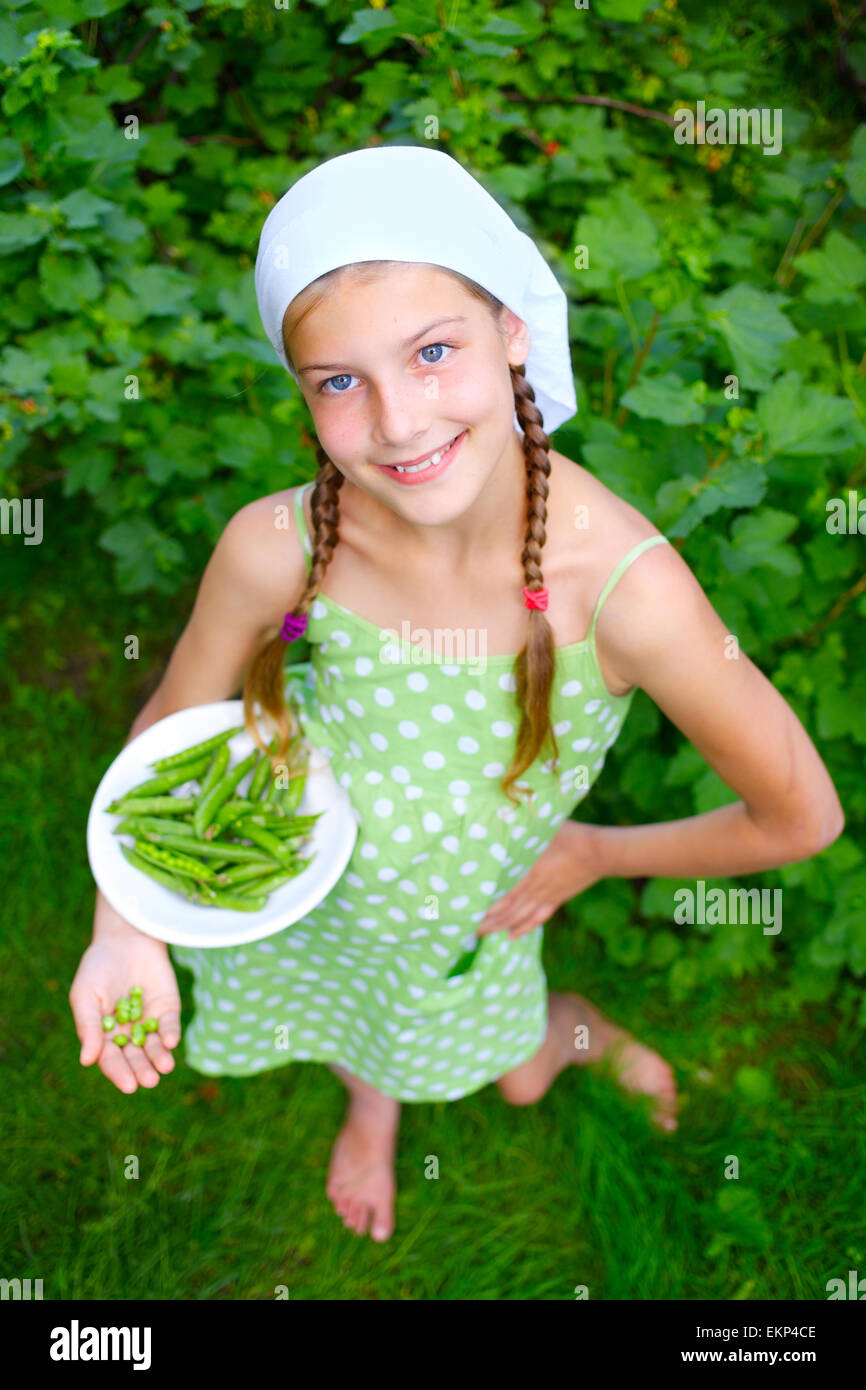 Girl holding a green Peas Stock Photo - Alamy