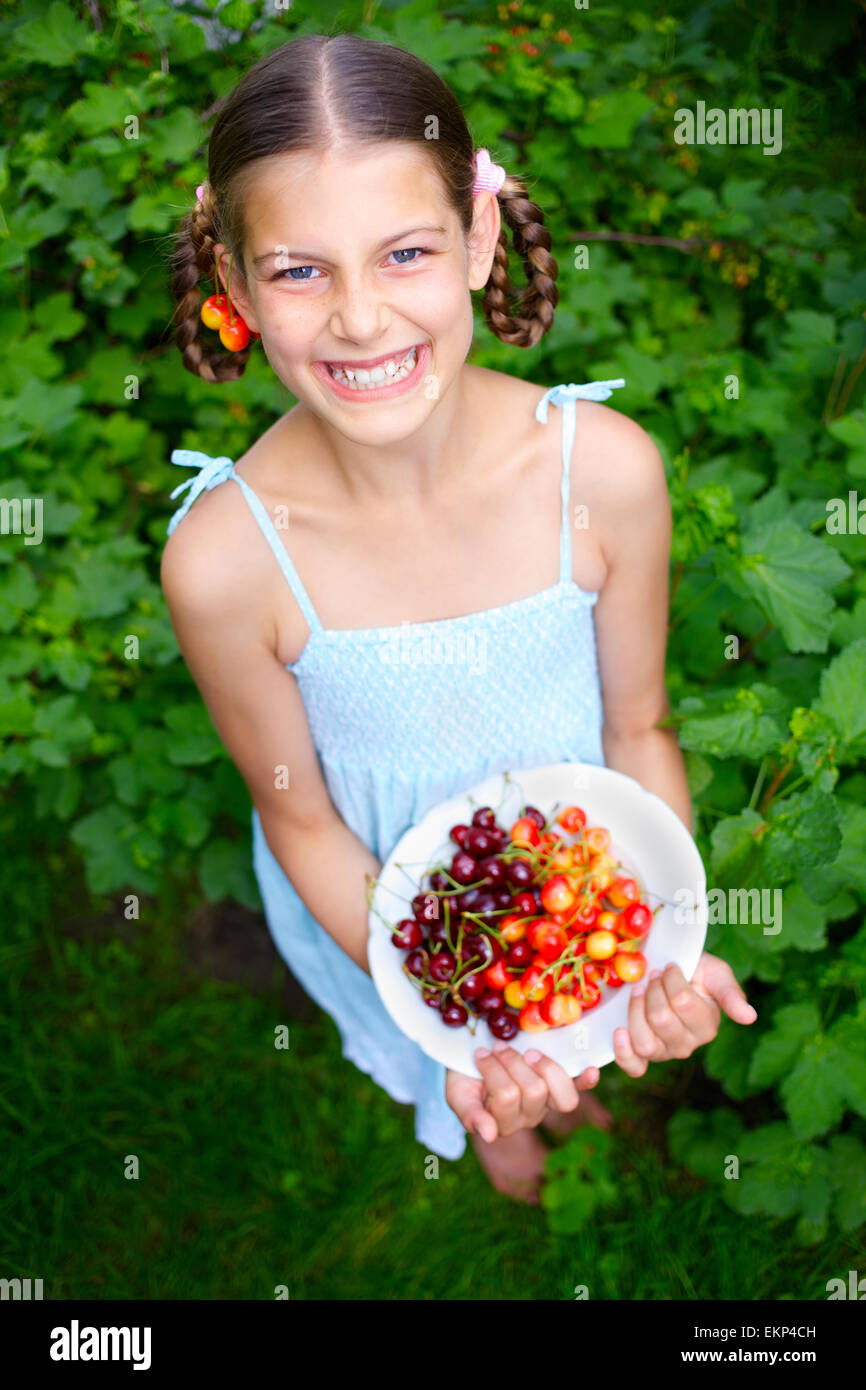 Girl eating cherries Stock Photo - Alamy