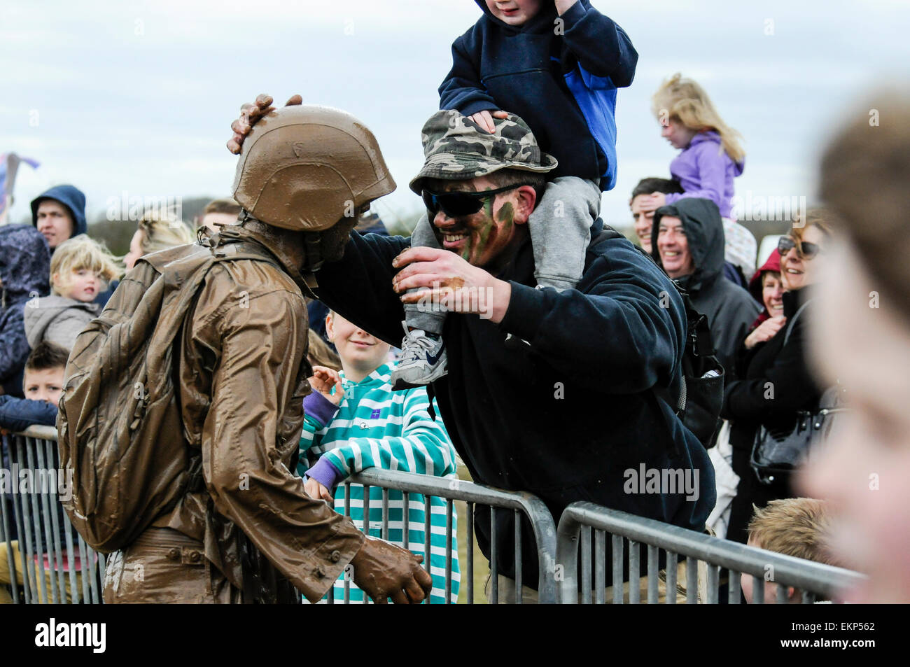 Soldier in full kit emerges from mud pool greets family at OCR event ...
