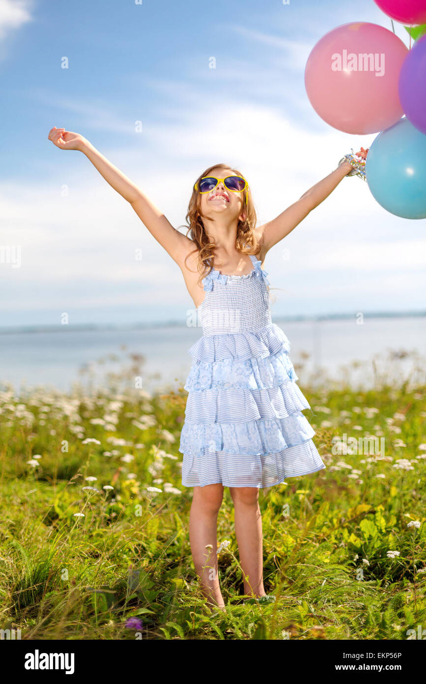 happy girl waving hands with colorful balloons Stock Photo - Alamy