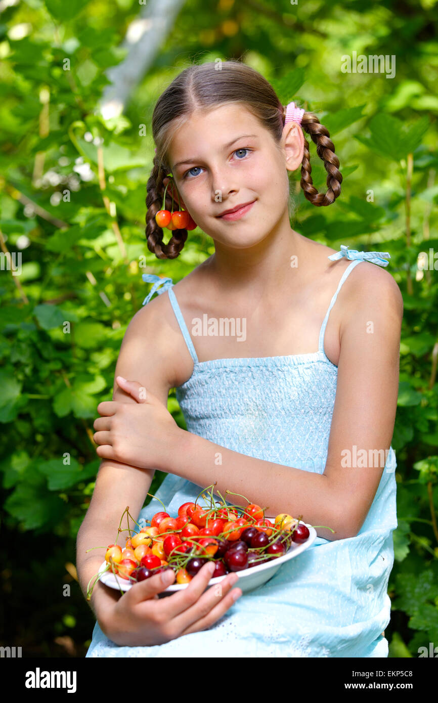 Girl eating cherries Stock Photo - Alamy