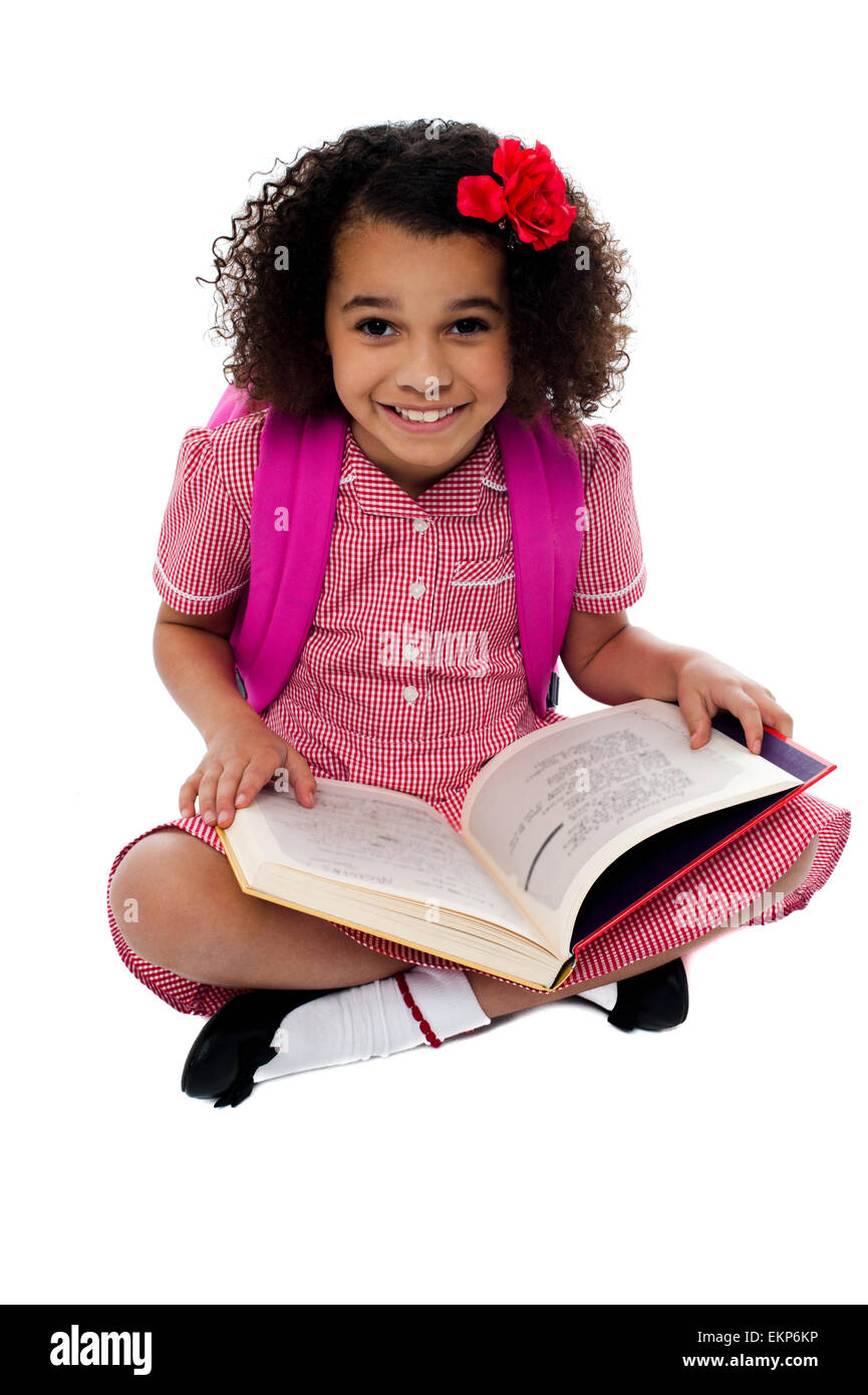 Smiling pretty school girl reading a book Stock Photo - Alamy