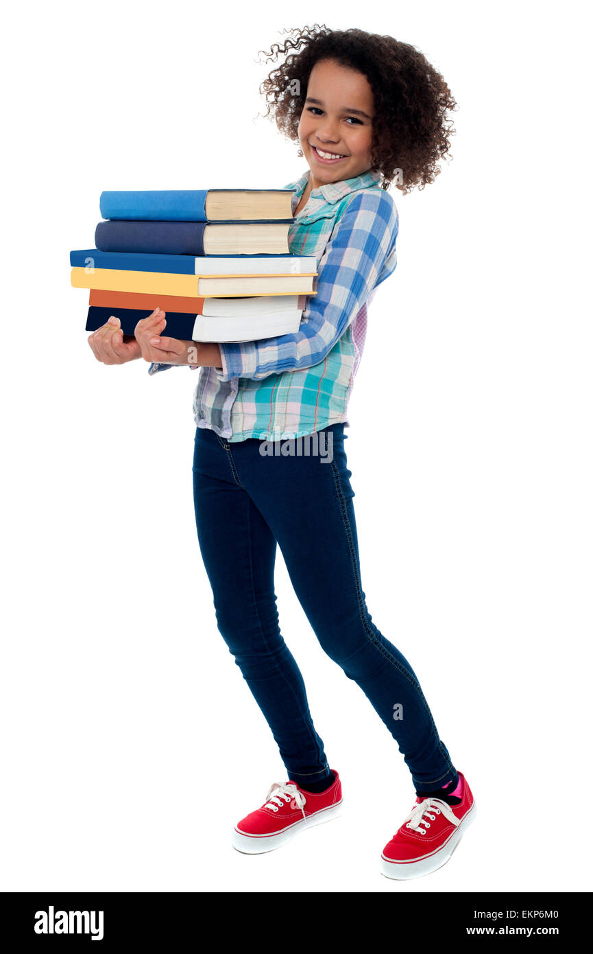 Active young school kid carrying books Stock Photo - Alamy