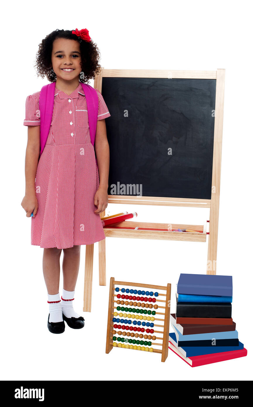 Smiling school girl standing near the blackboard Stock Photo - Alamy