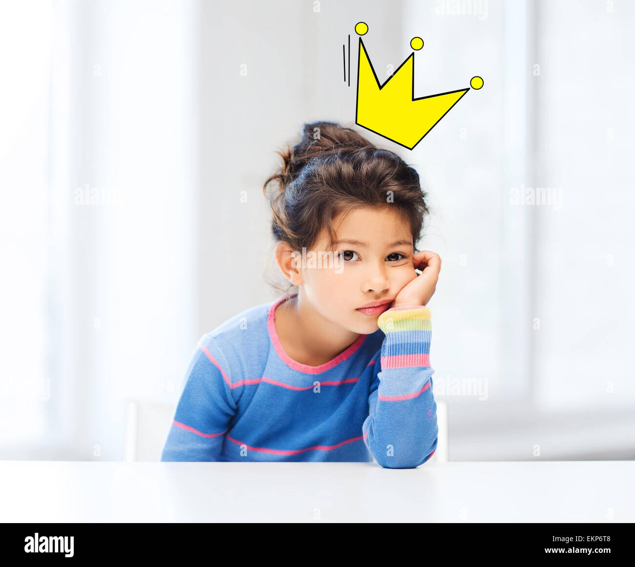 bored little girl with crown doodle over head Stock Photo - Alamy