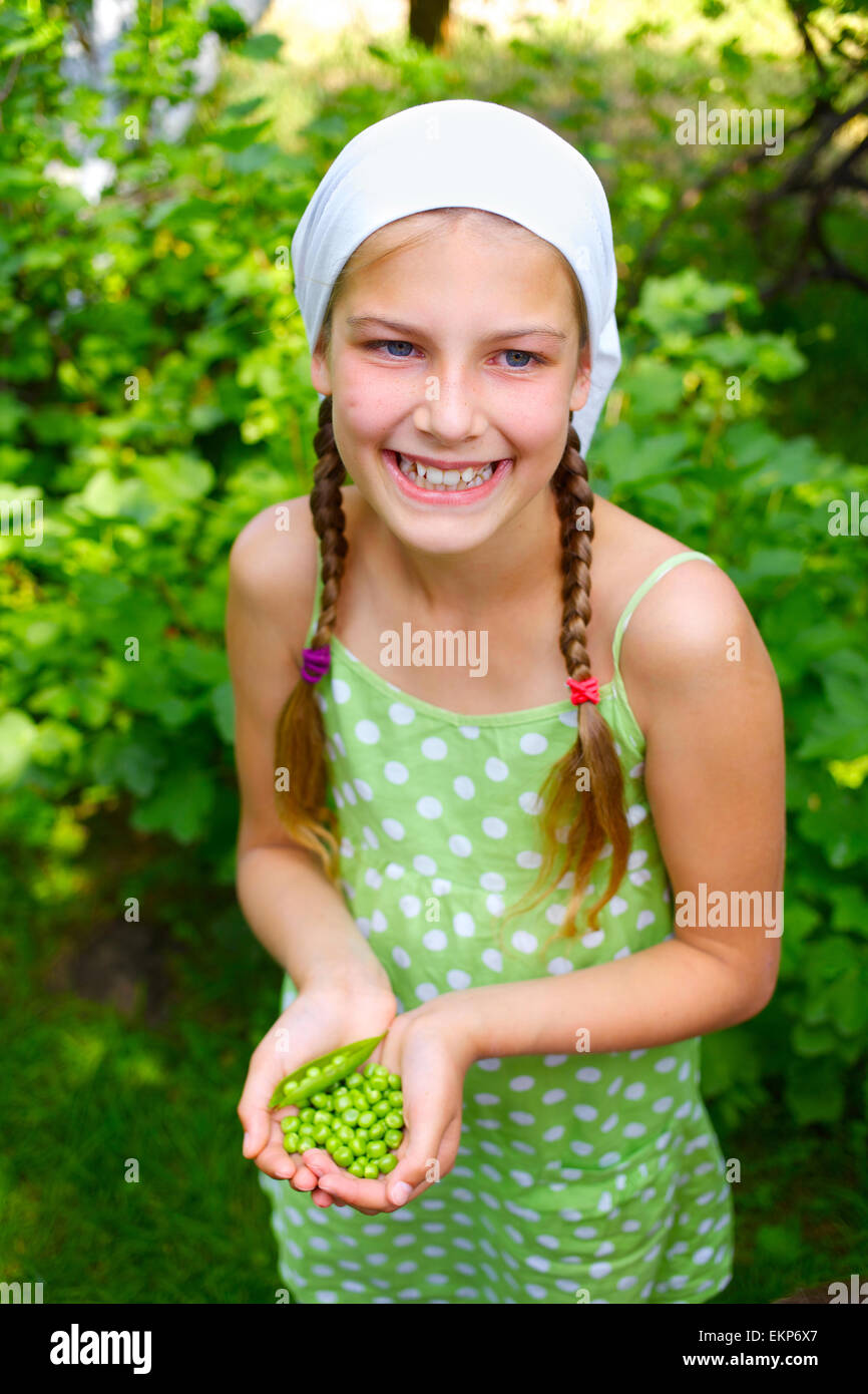 Girl holding a green Peas Stock Photo - Alamy