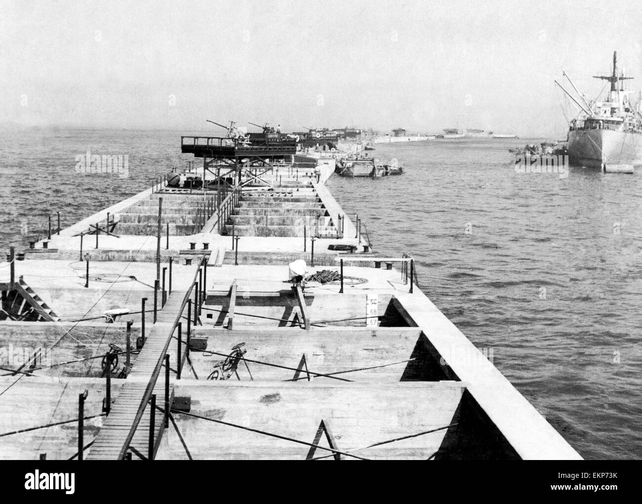 A liberty ship inside the outer wall of the Mulberry harbour just off ...