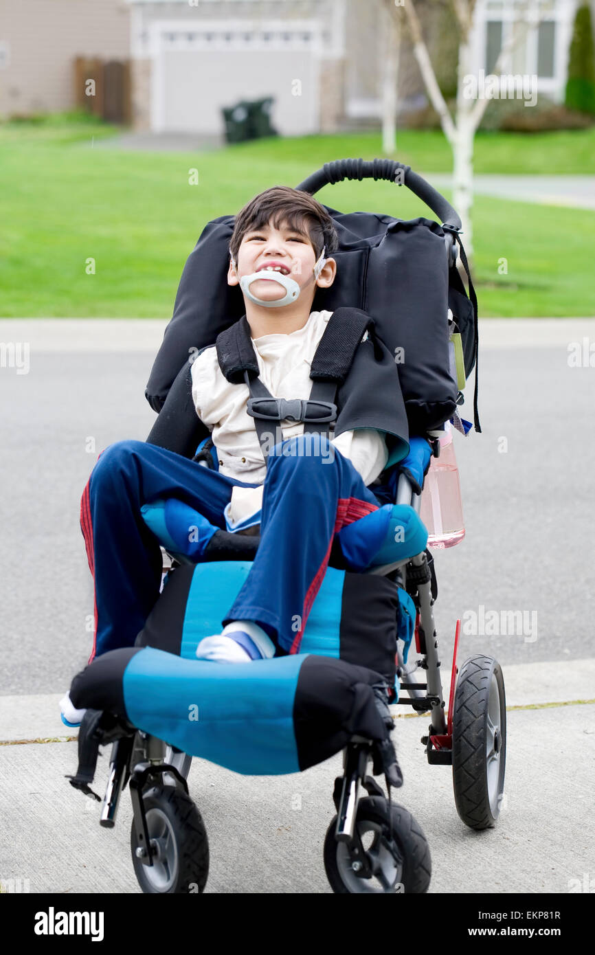 Happy little disabled boy in wheelchair Stock Photo - Alamy