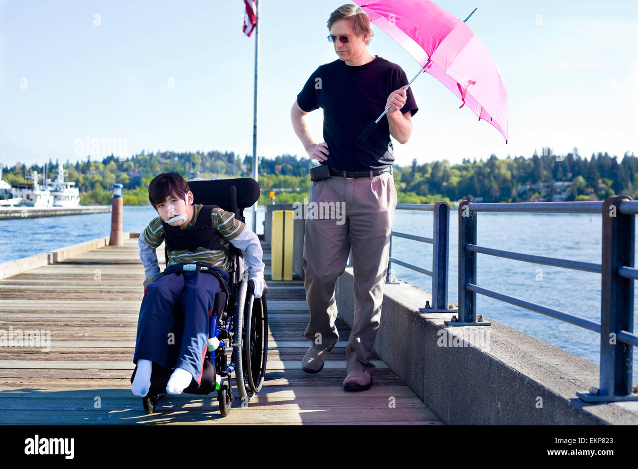 Father walking disabled son in hi-res stock photography and images - Alamy