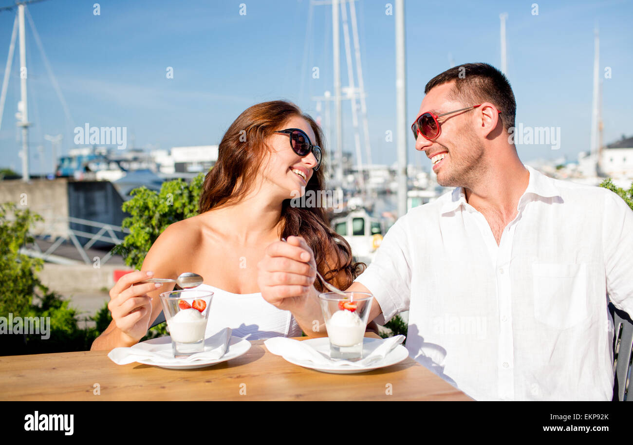 smiling couple eating dessert at cafe Stock Photo - Alamy