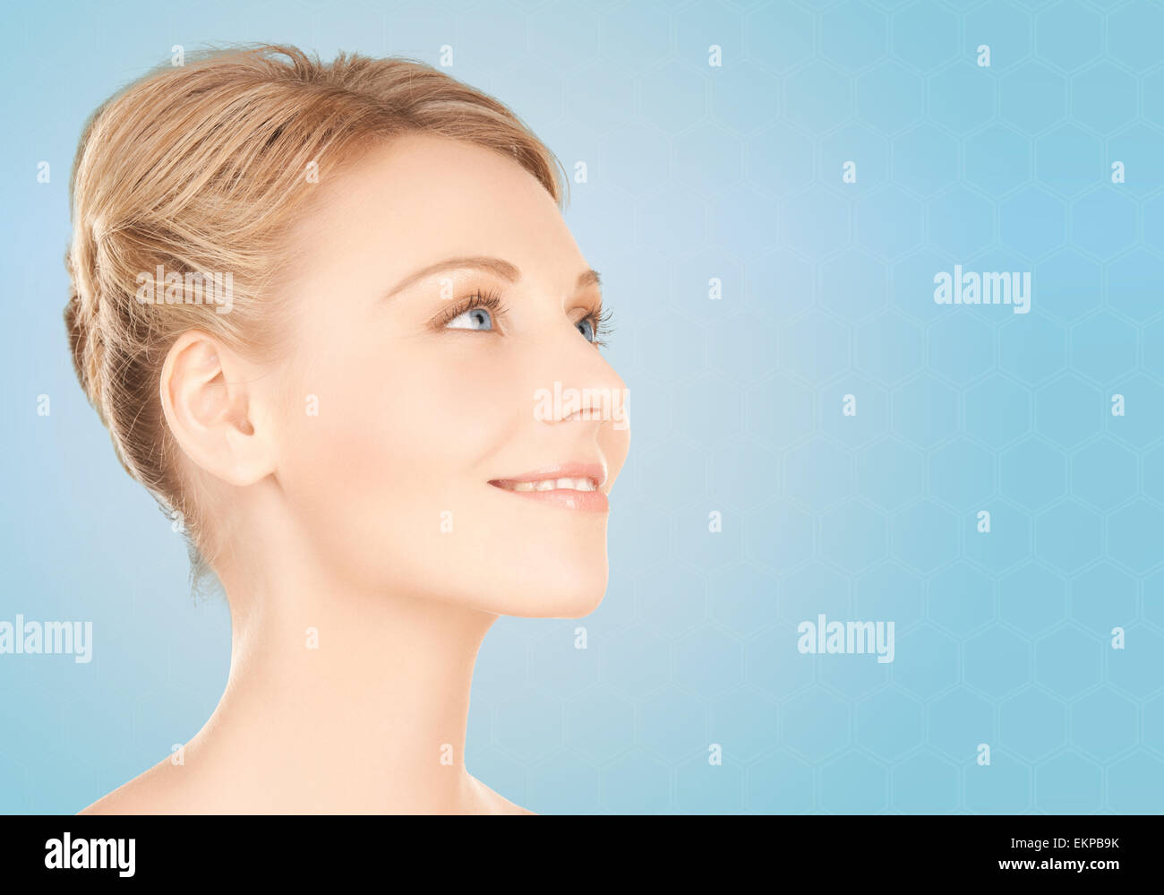 beautiful young woman face over blue background Stock Photo - Alamy