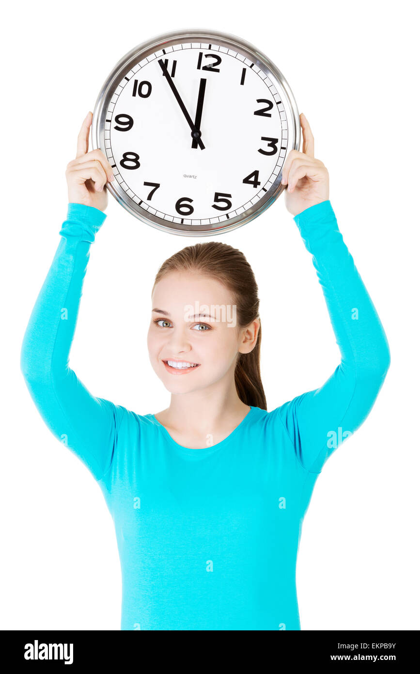 Happy young woman holding office clock Stock Photo - Alamy