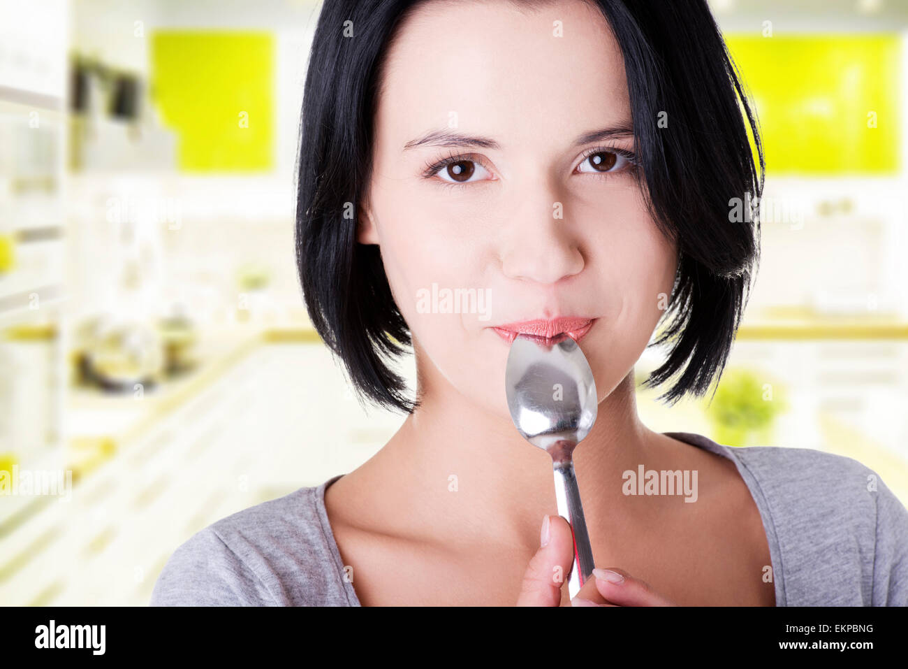Young smiling woman with spoon Stock Photo - Alamy