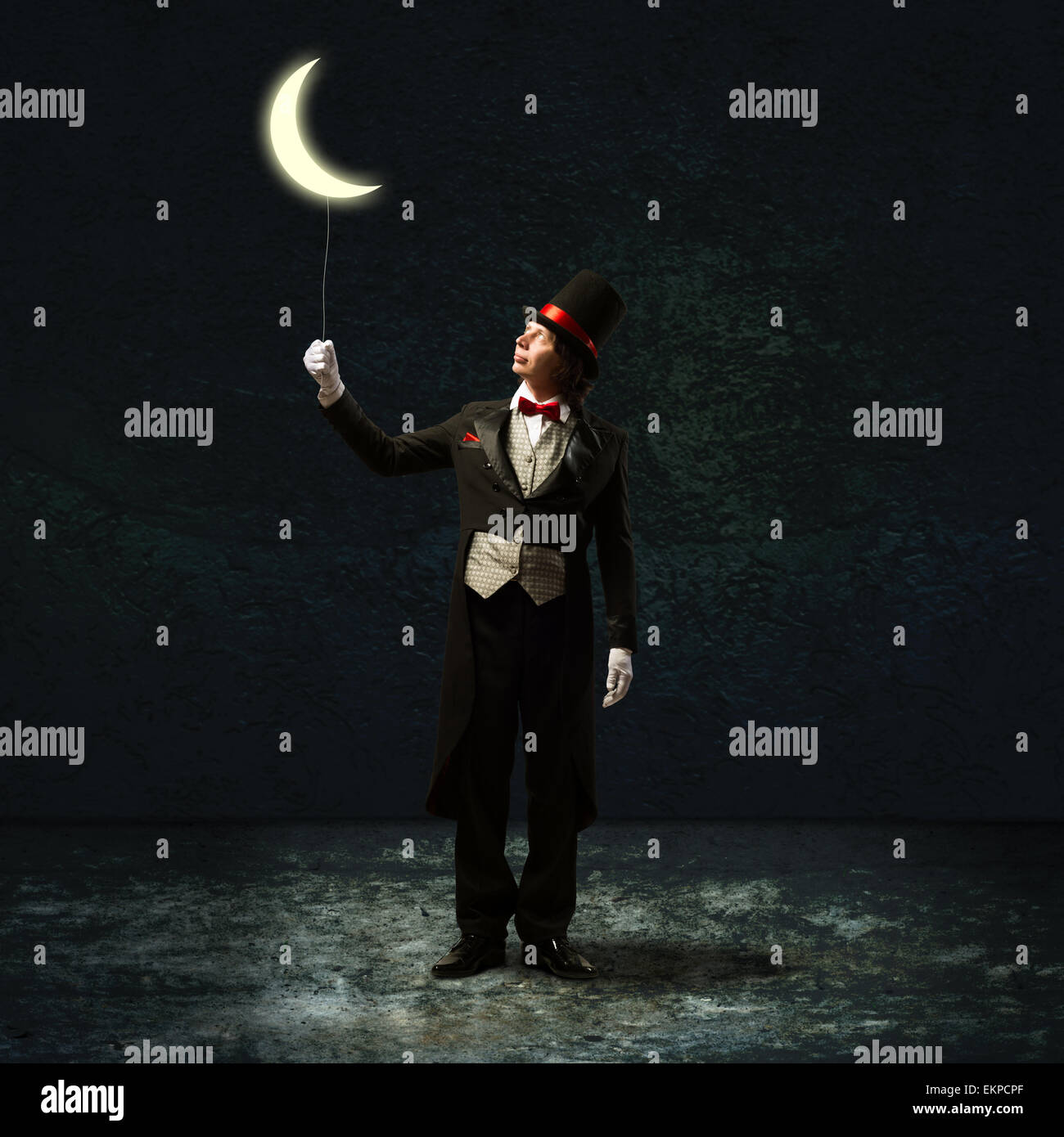 magician keeps the moon on a string Stock Photo - Alamy