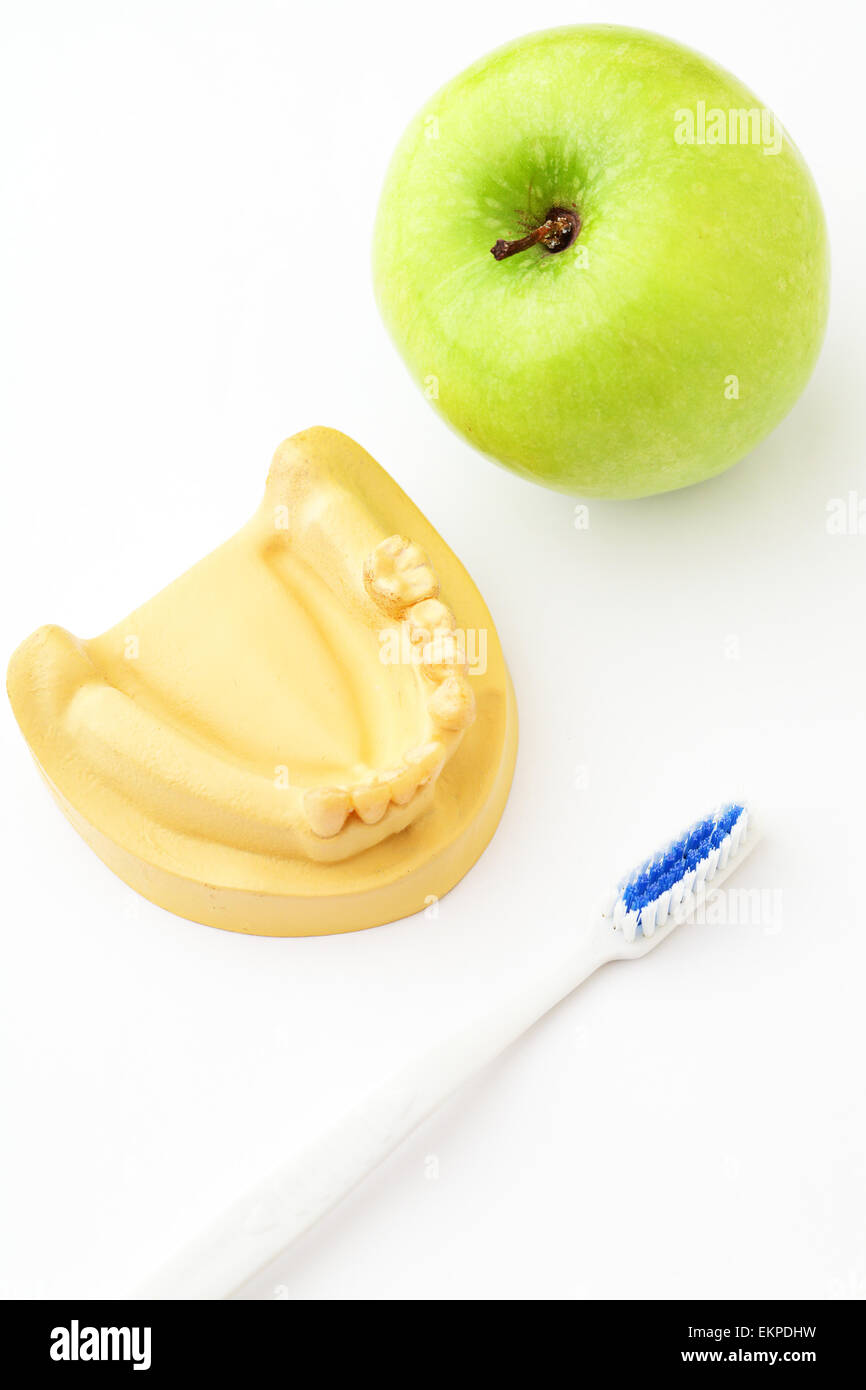 Green apple, toothbrush and denture Stock Photo - Alamy