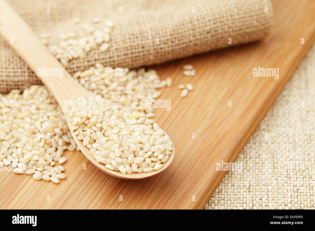 Uncooked rice on spoon Stock Photo - Alamy