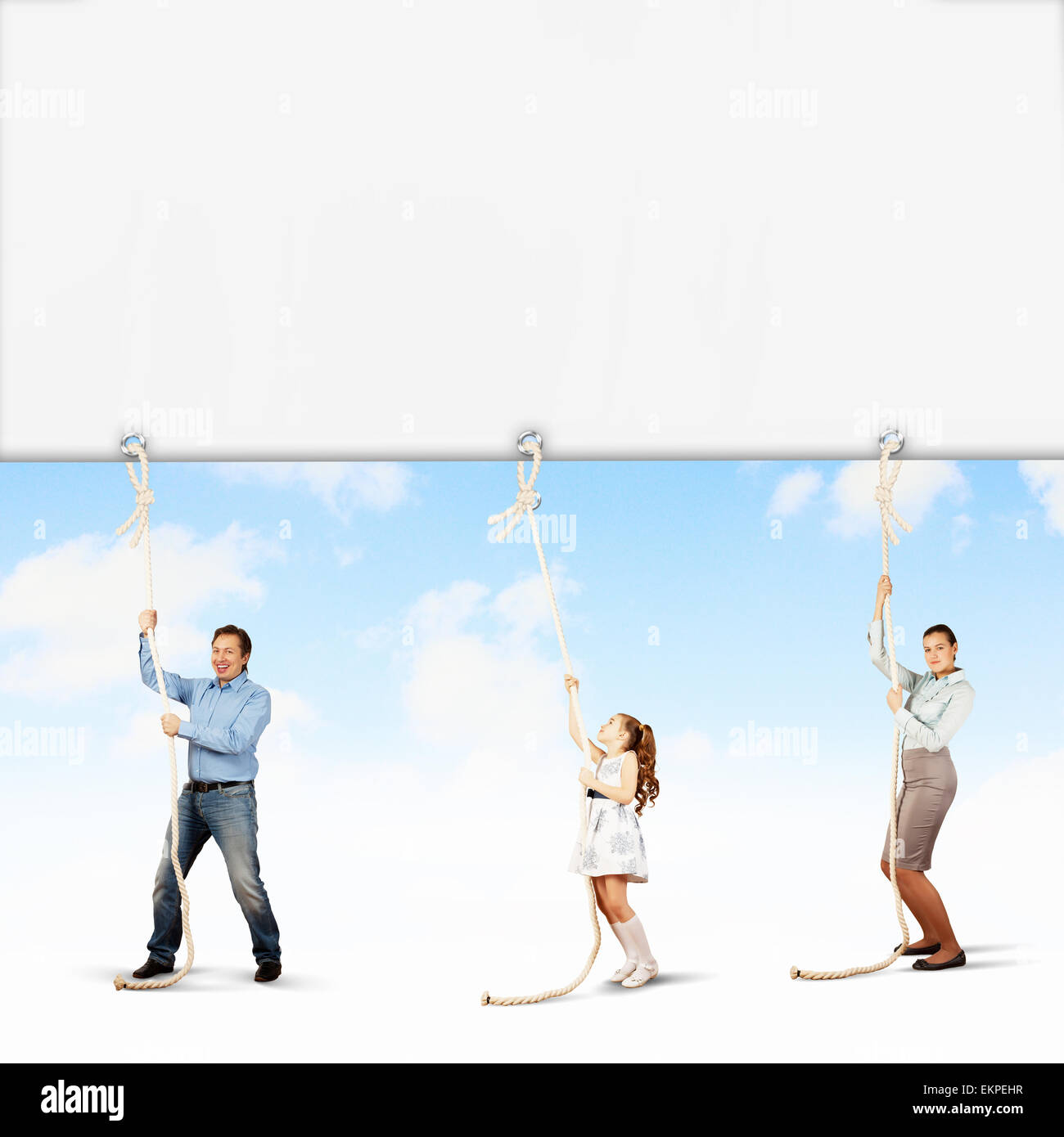 Family pulling banner Stock Photo - Alamy