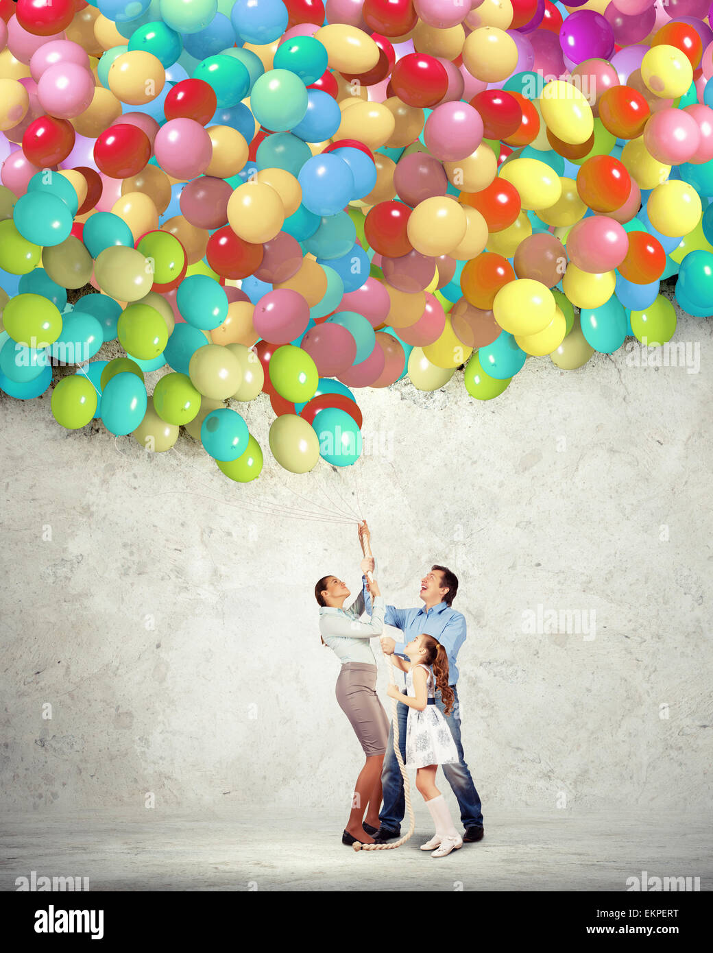 Family holding colorful balloons Stock Photo - Alamy