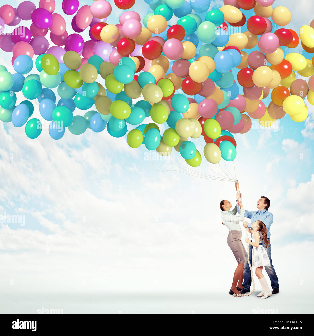 Family holding colorful balloons Stock Photo - Alamy