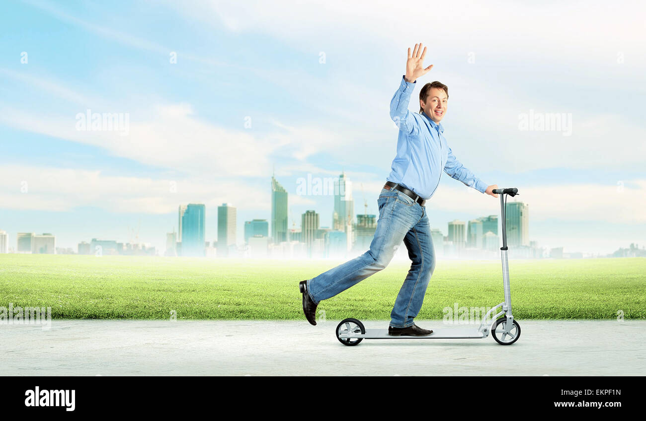 Businessman riding scooter Stock Photo - Alamy