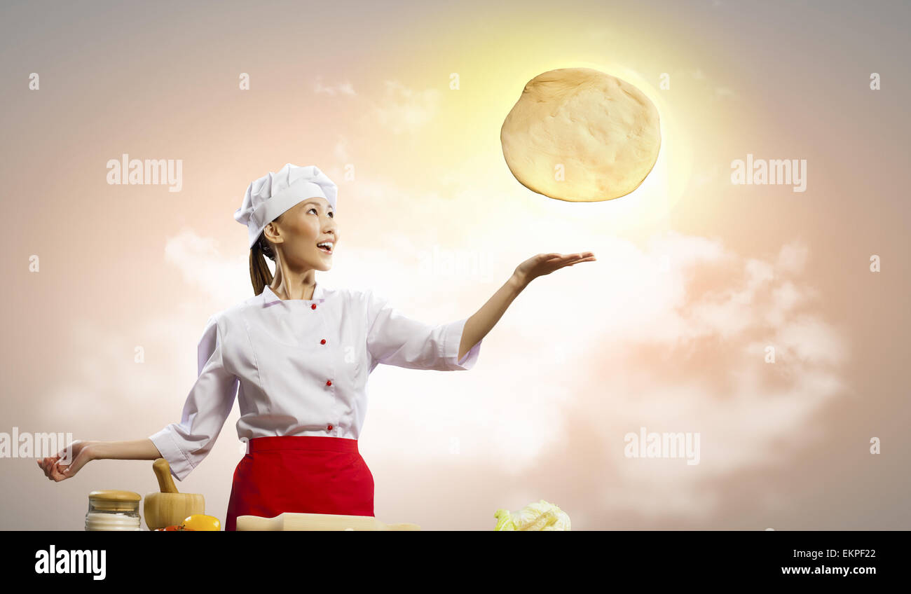 Asian female cook making pizza Stock Photo - Alamy