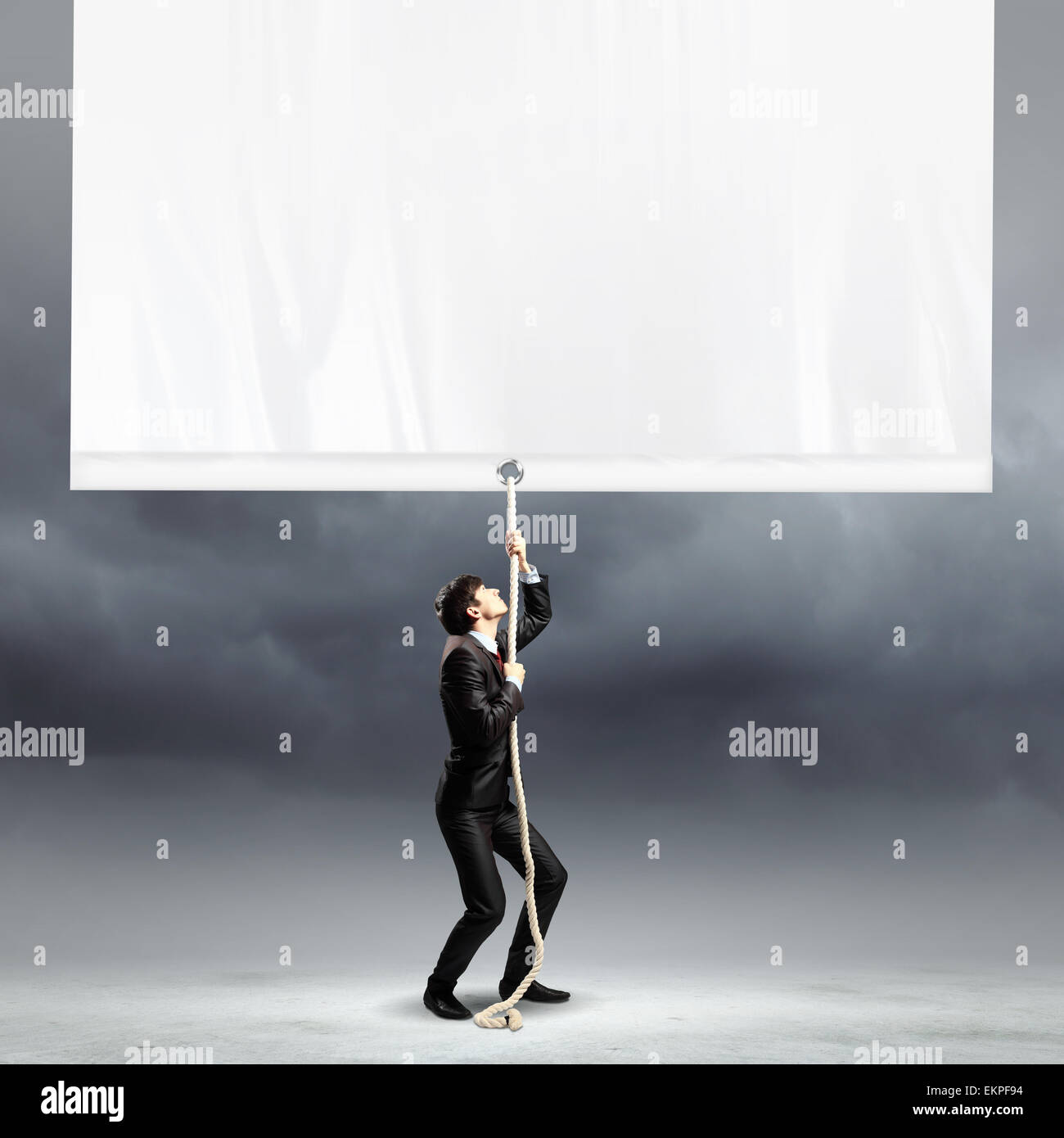 Businessman pulling blank banner Stock Photo - Alamy